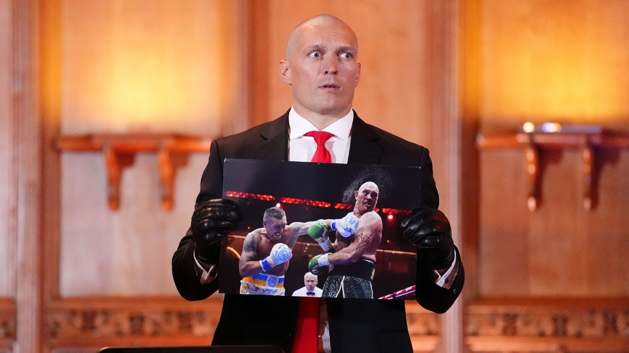 'Hitman' Usyk has Fury sign photo of 1st fight punch at news conference ...